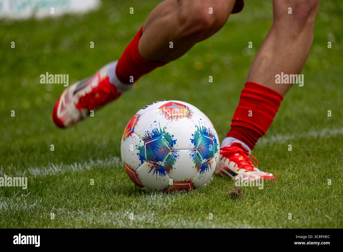 Footballer takes a corner kick***The ball is the official match ball of ...