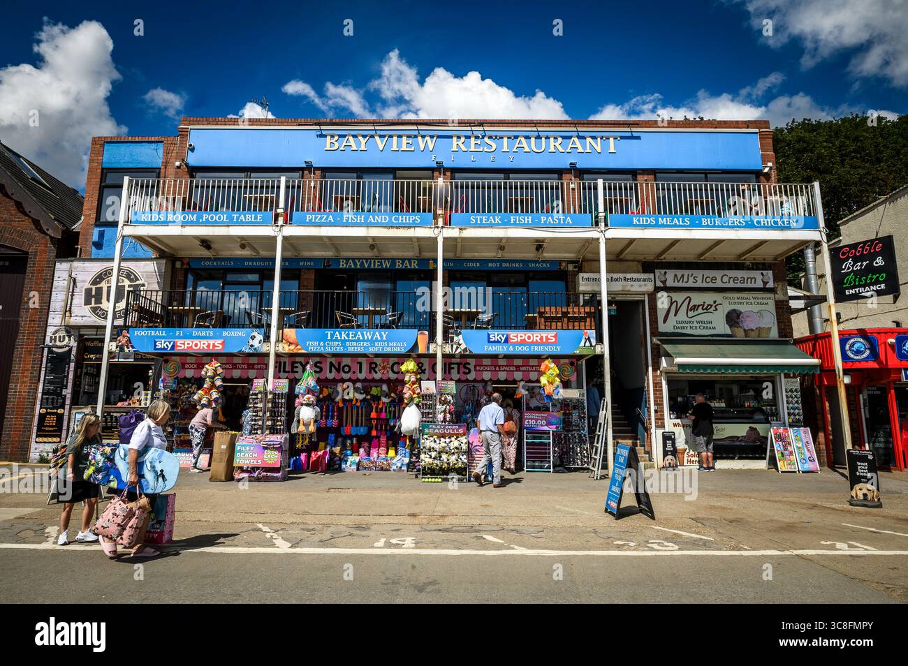Filey, North Yorkshire, UK, July 22, 2025. Cafe's, amusements and beach ...