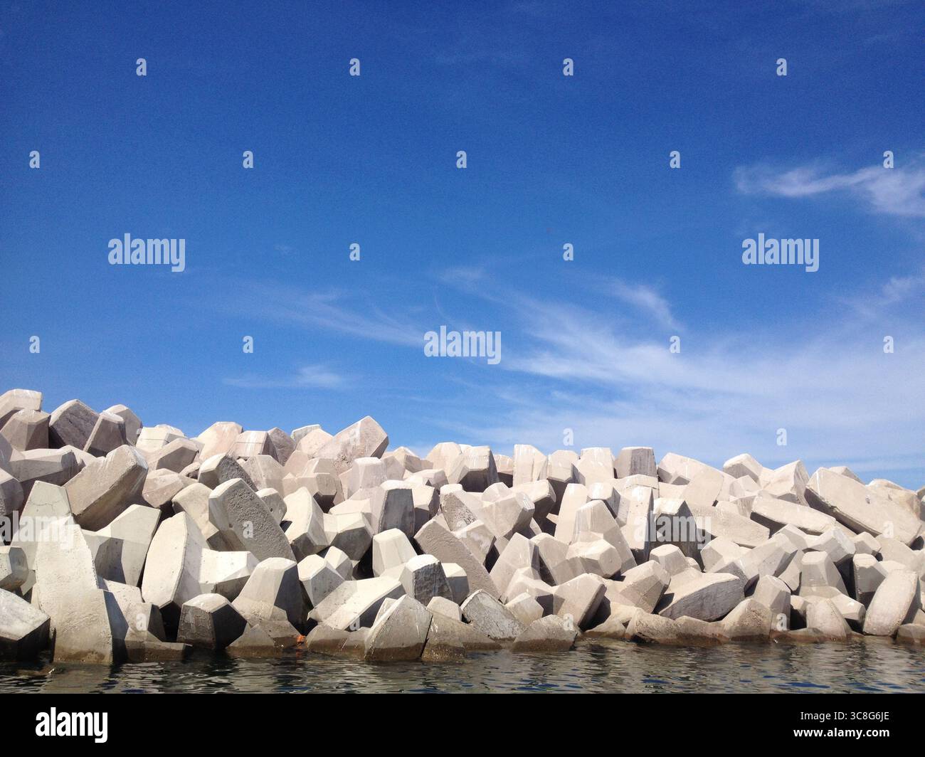 Concrete breakwater blocks defending coastal area against sea erosion, positioned along Ortona ...