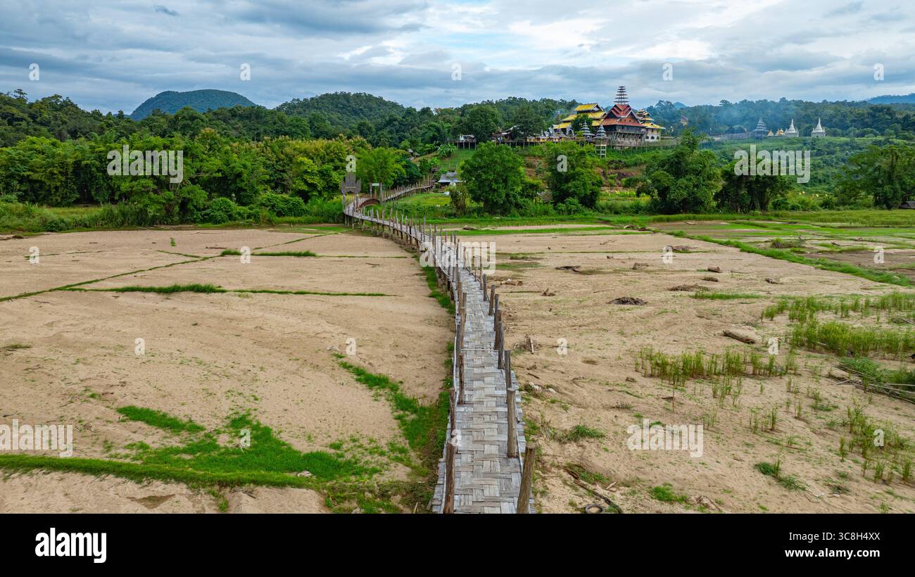 Aerial view Amazing beauty in the hill tribe village.The bridge snaking ...