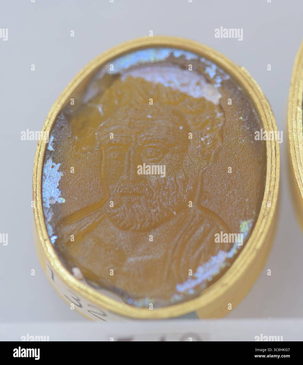 An ancient Roman glass intaglio with a portrait of a man, displayed at ...
