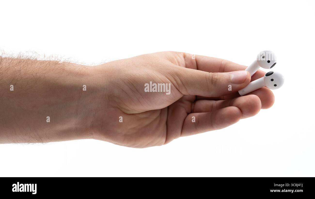 Hand holding wireless earbuds for listening music Stock Photo - Alamy
