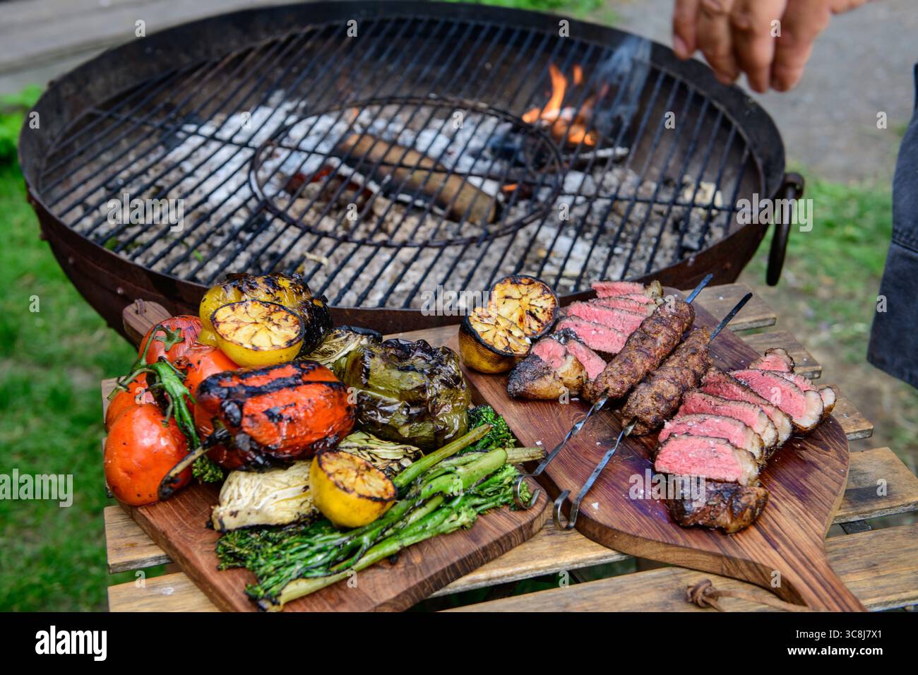 Slices of rump cap beef cooked on a kadai or open fire bowl Stock Photo - Alamy