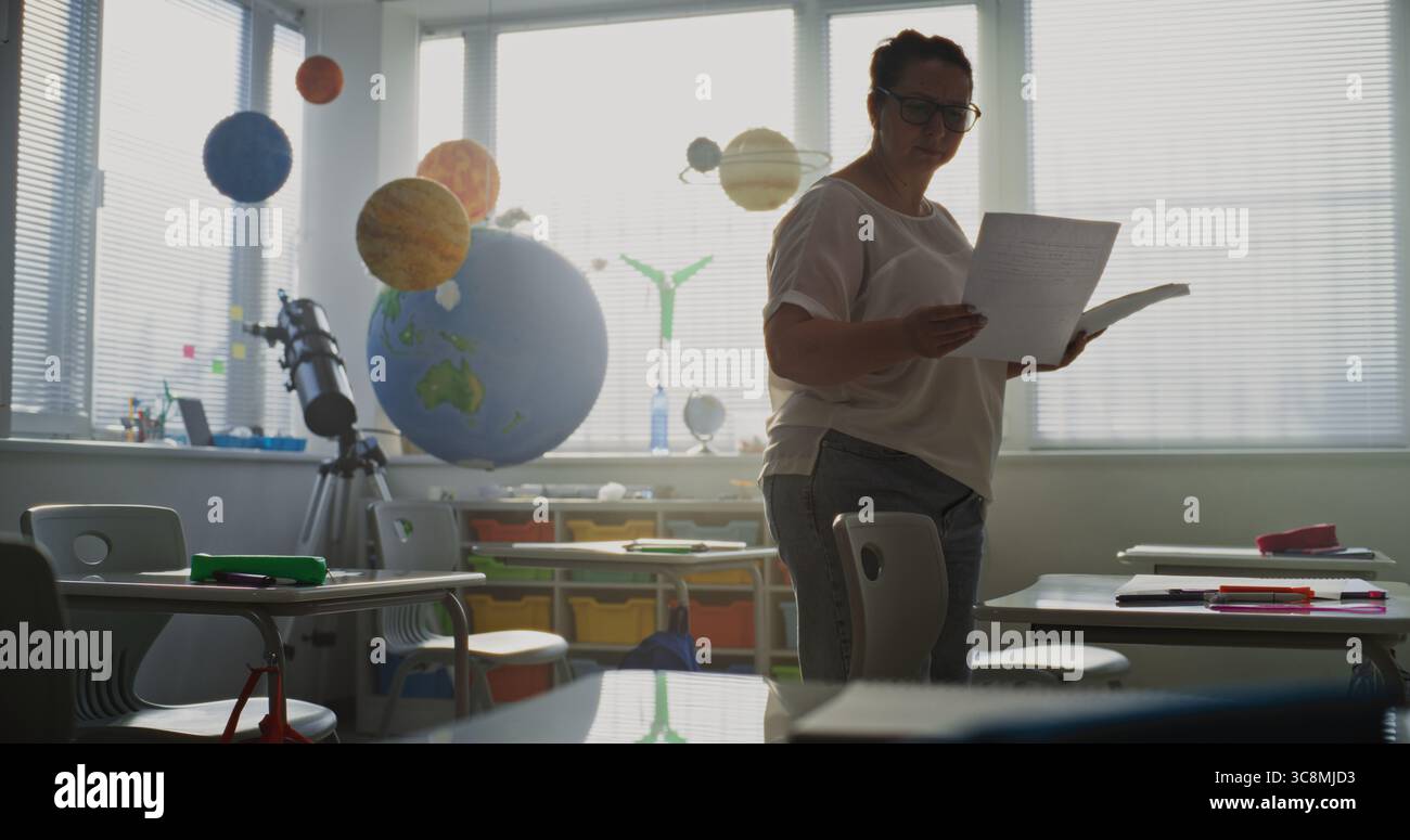 Female teacher laying out worksheets hi-res stock photography and ...