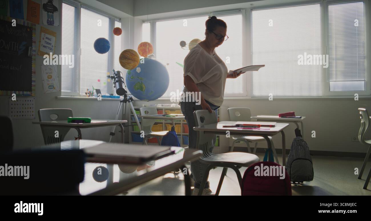Female teacher laying out worksheets hi-res stock photography and ...