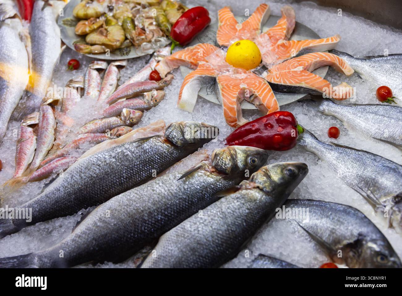 A vibrant display of fresh seafood including fish, shrimp, and salmon ...