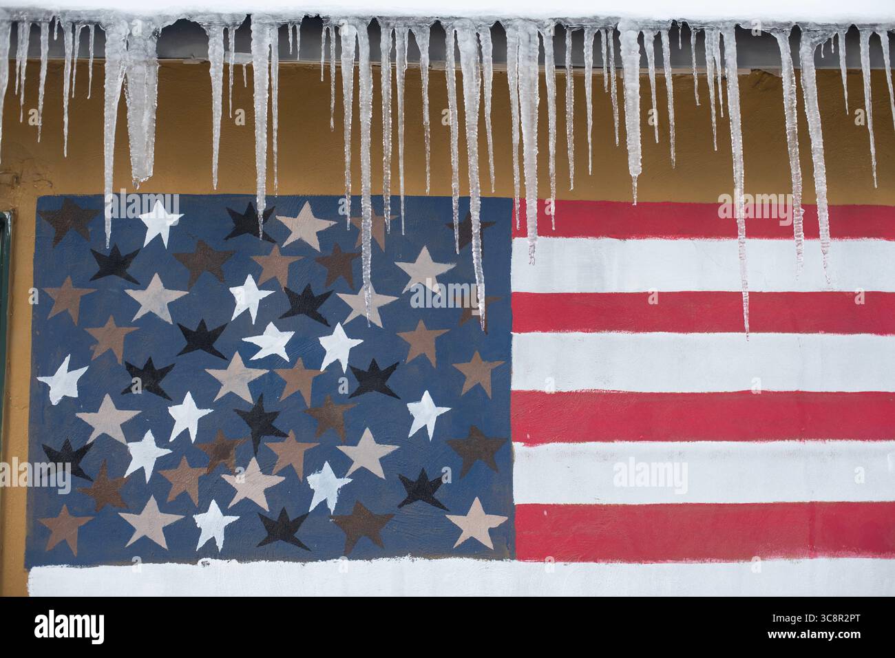 February 15, 2021, Austin, Texas, USA: Icicles drop from a roof as snow ...