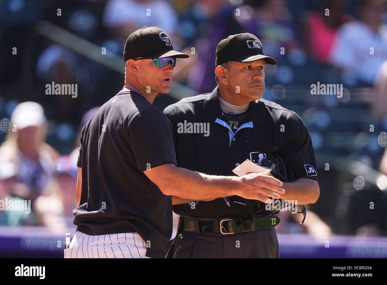 Colorado Rockies interim manager Warren Schaeffer (34) confers with ...