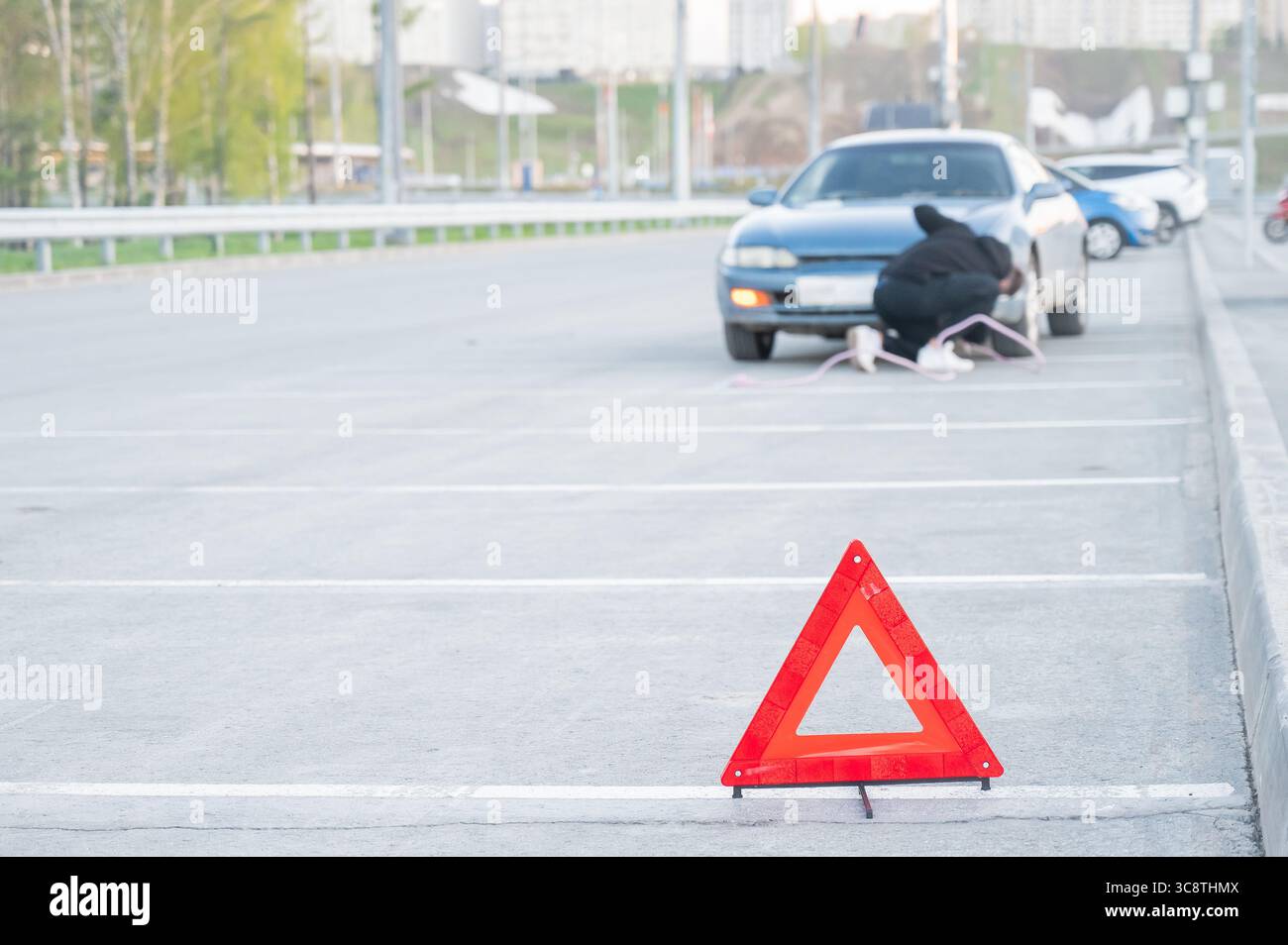 Warning triangle man disconnects tow hi-res stock photography and ...