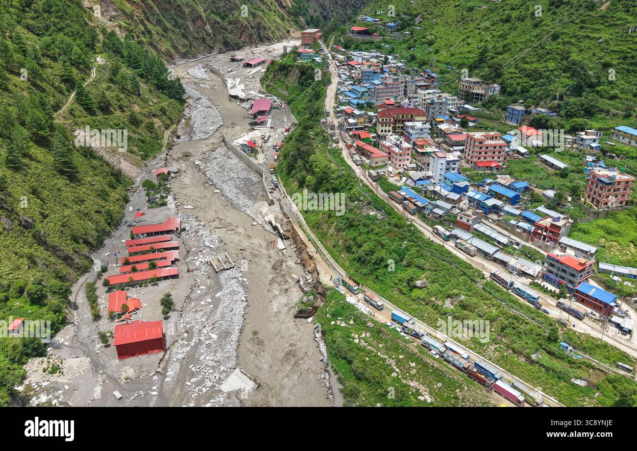 FILE - Damaged buildings, on left, are visible after severe monsoon ...