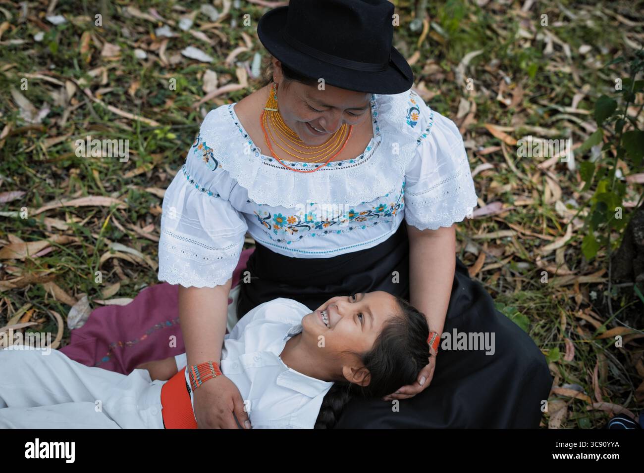 Indigenous mother embracing daughter in traditional clothing Stock ...
