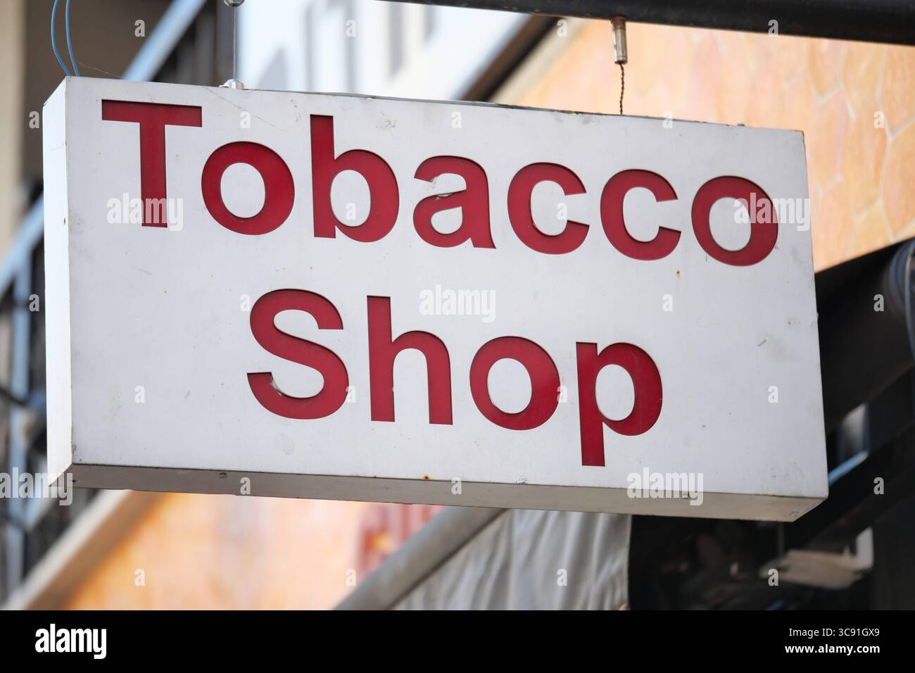 Tobacco shop sign displayed on urban street Stock Photo - Alamy