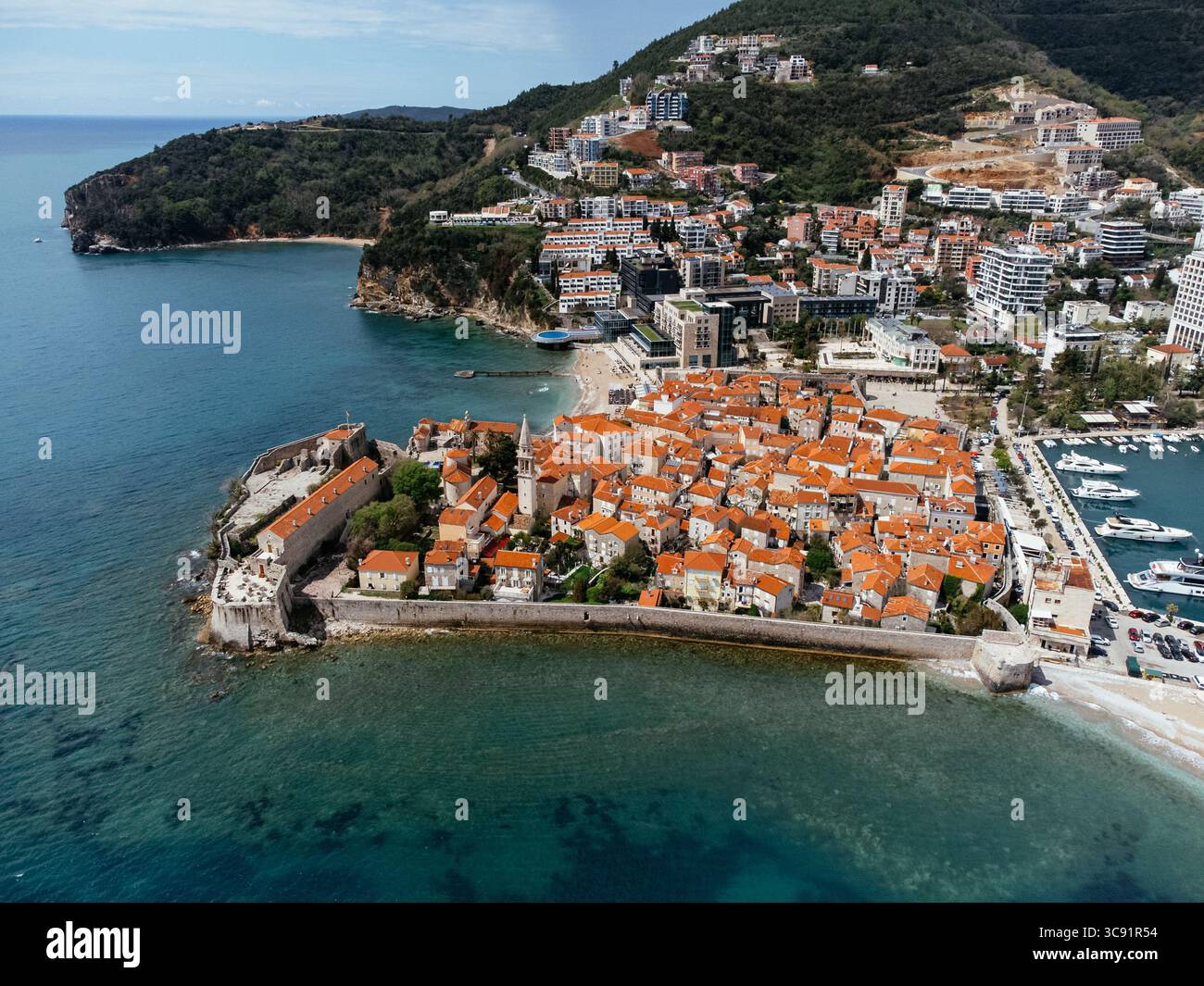 Aerial view of the Old Budva town, port, beach, and mountains Stock ...