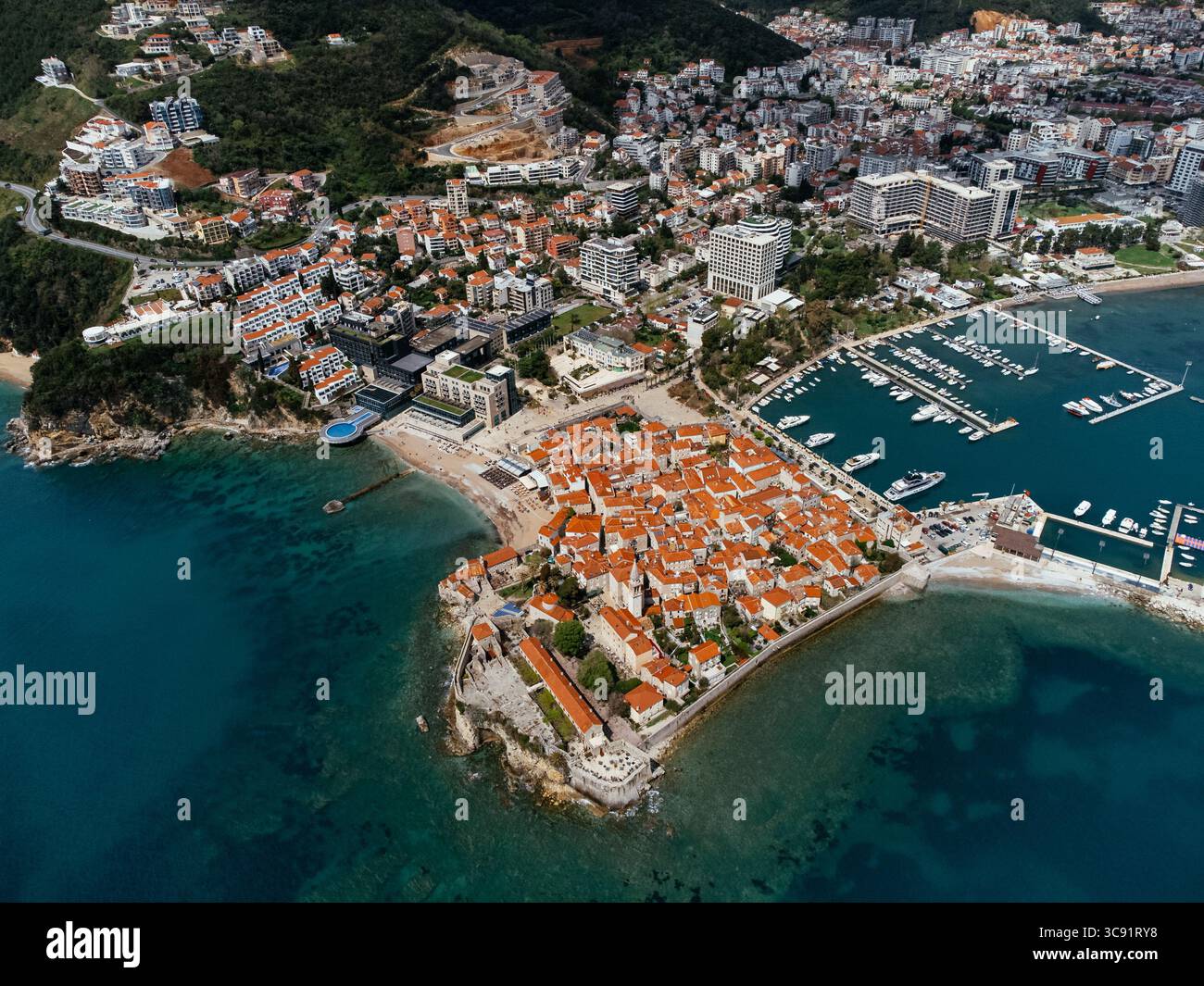 Aerial view of the Old Budva town, port, beach, and mountains Stock ...