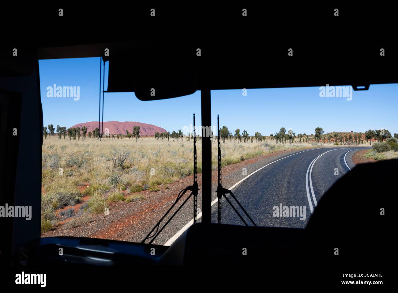 Uluru from the tourist bus. In Kata Tjuṯa National Park in the Northern ...
