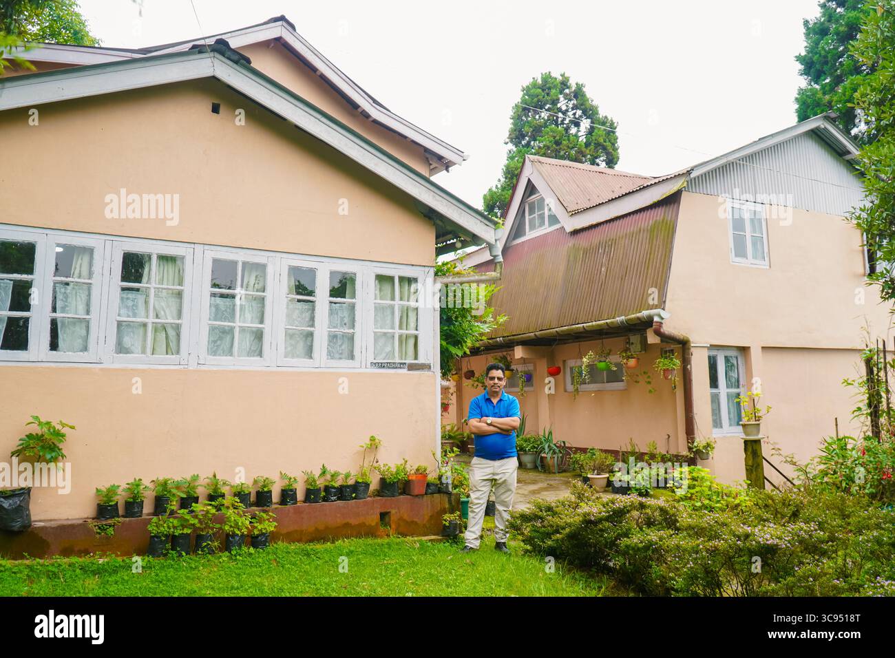 Man Standing in Front of Traditional Countryside House with White ...