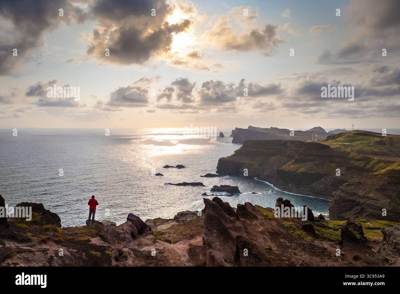Aerial view of a tourist admiring sunrise over Sao Lourenco peninsula ...