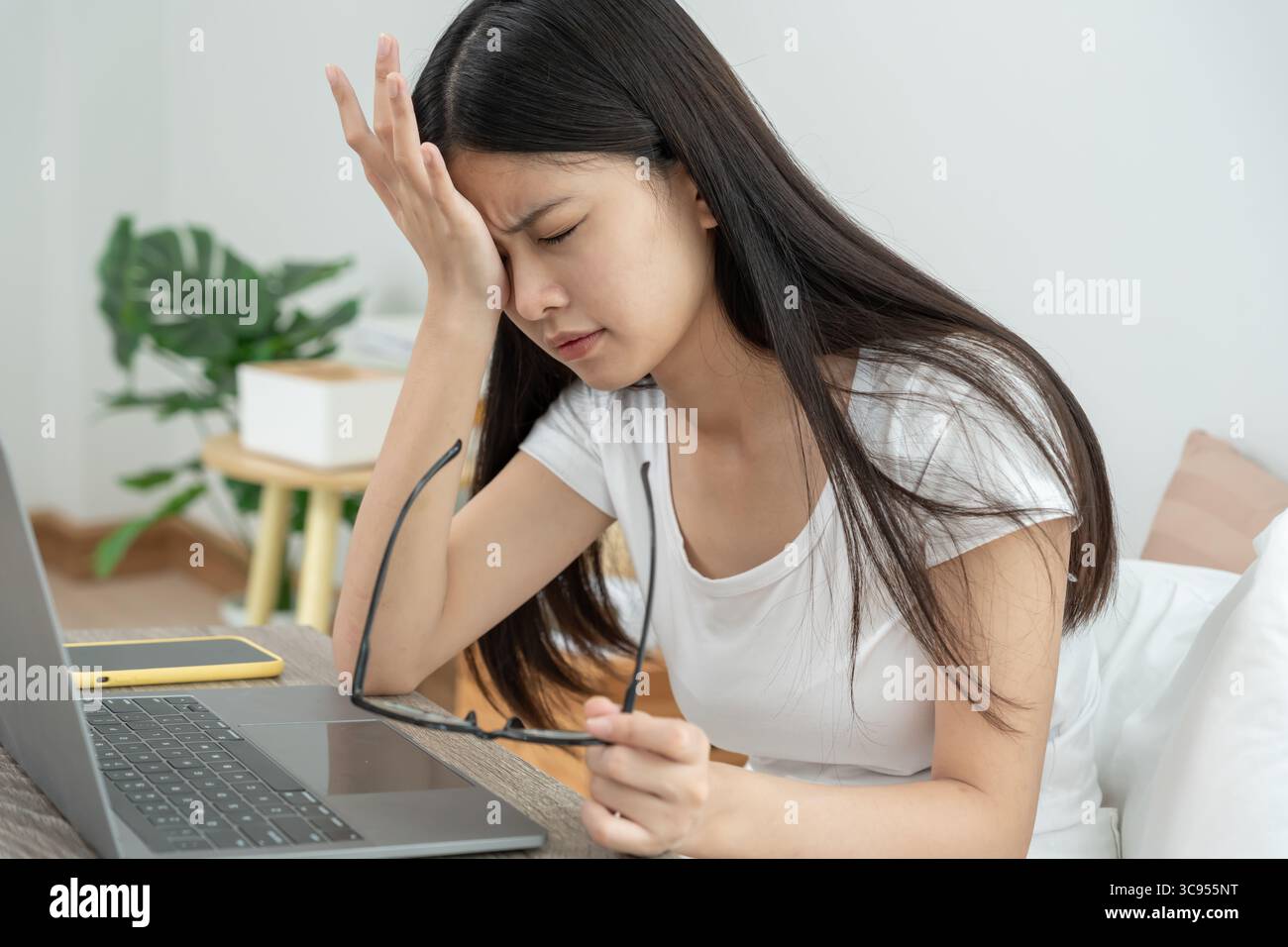 Eye problems, Asian women with tired and irritated eyes, eye rubbing ...
