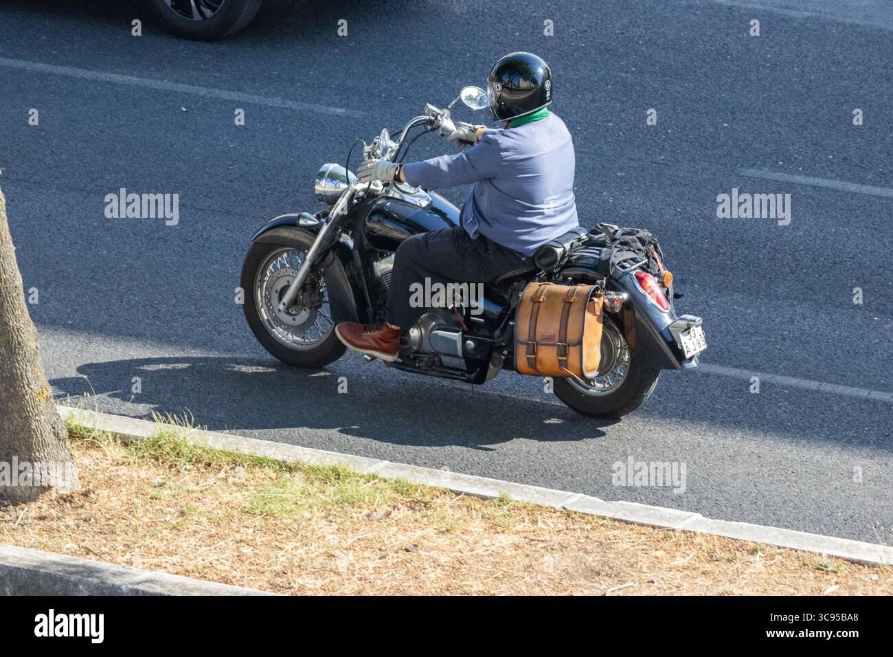 Motorcyclist wearing helmet and gloves is riding custom chopper ...