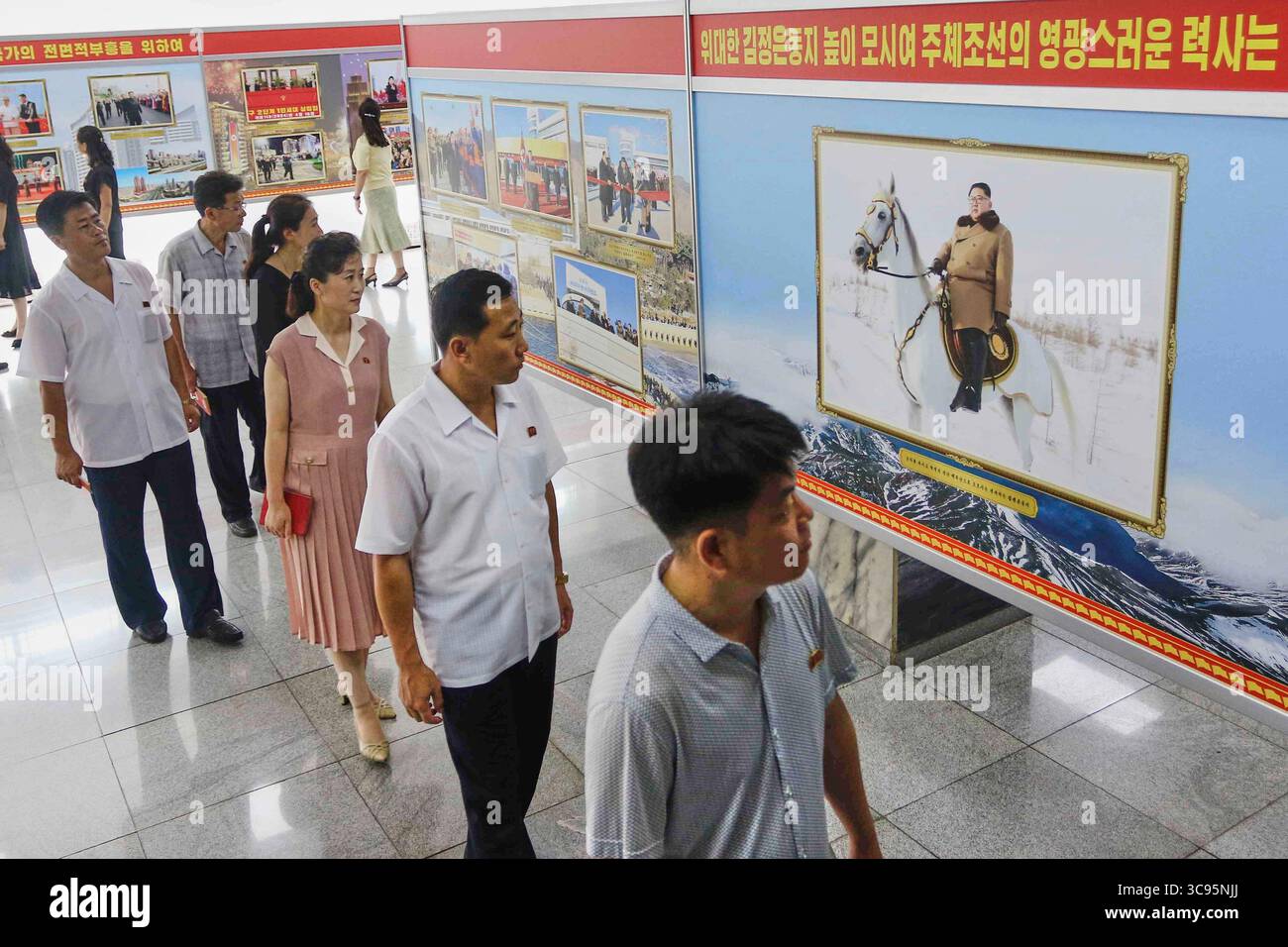 Pyongyang citizens look at a national photo exhibition "Great victory ...