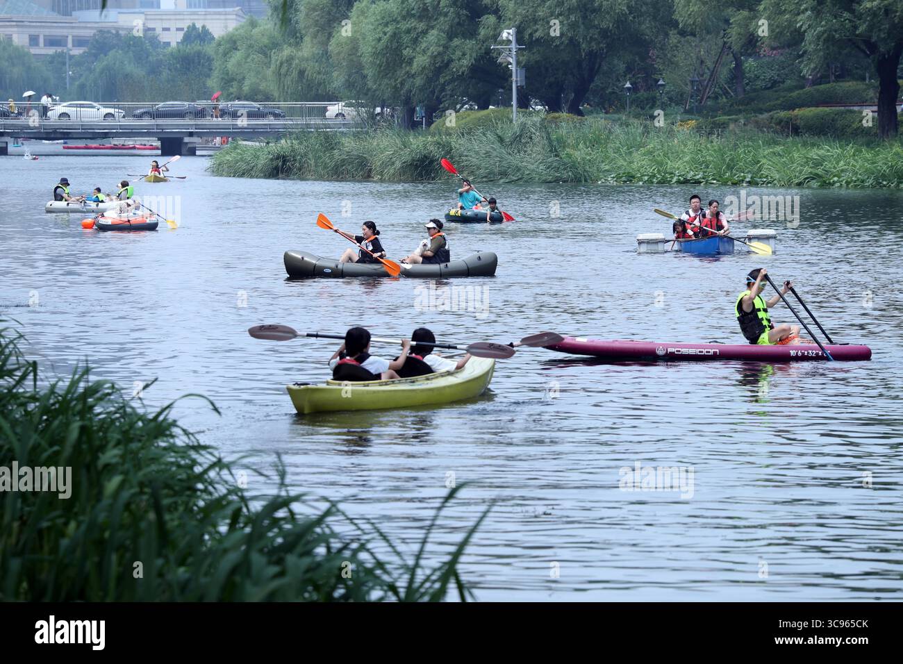 People experience canoeing on Liangma River in Beijing, China, 2 August ...