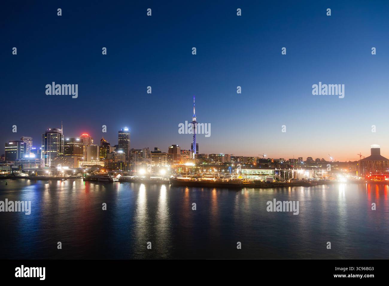 Night city of Auckland New Zealand. Glowing skyscrapers, bay and ...