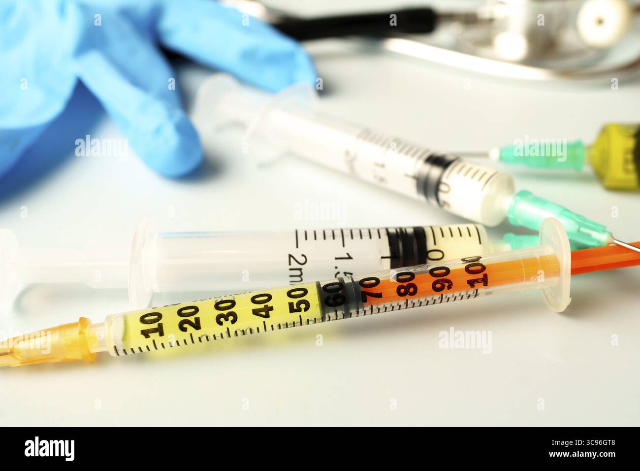 Medical equipment including syringes, stethoscope and gloves laying on ...