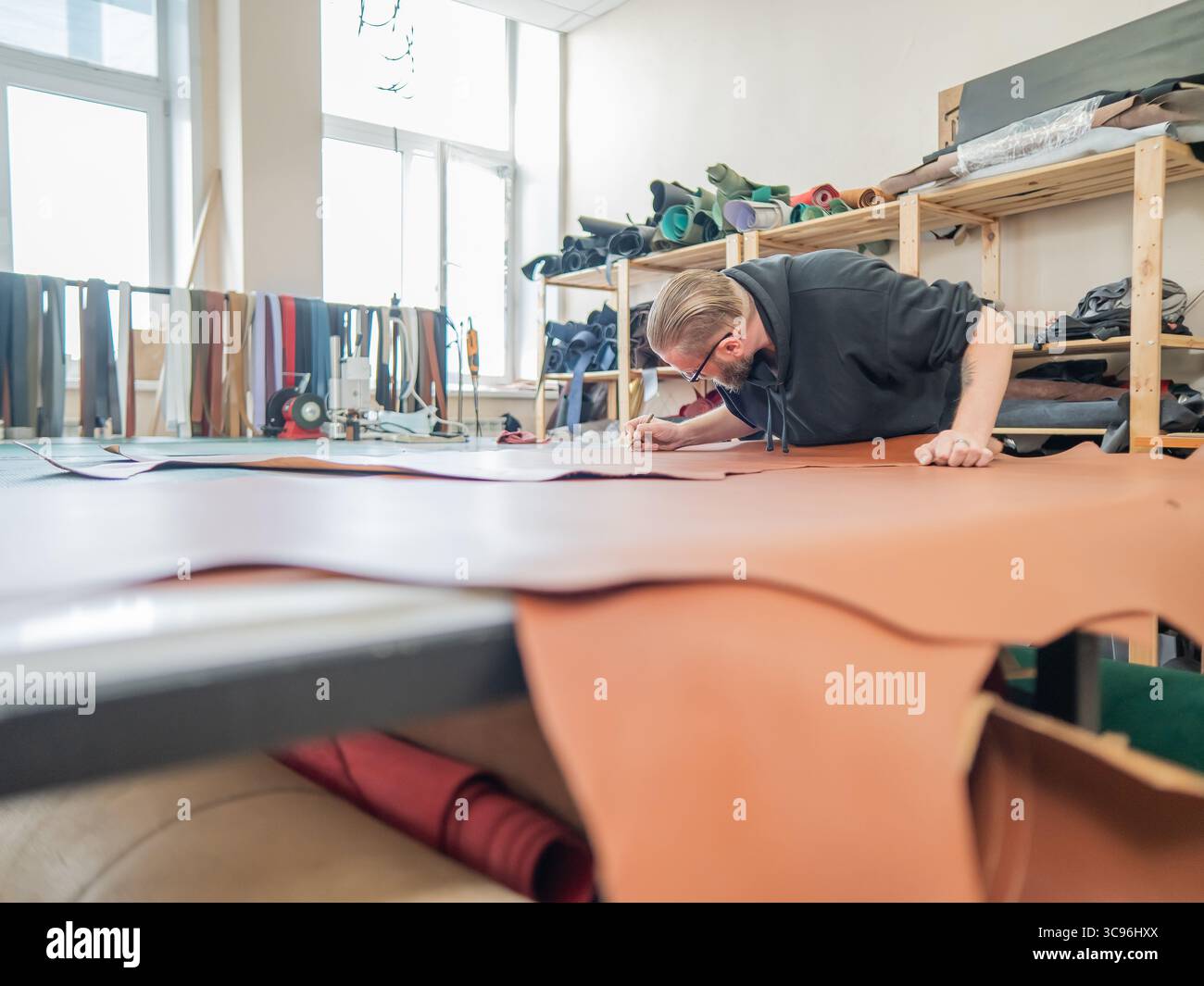 Caucasian bearded man working as a tanner in a workshop Stock Photo - Alamy