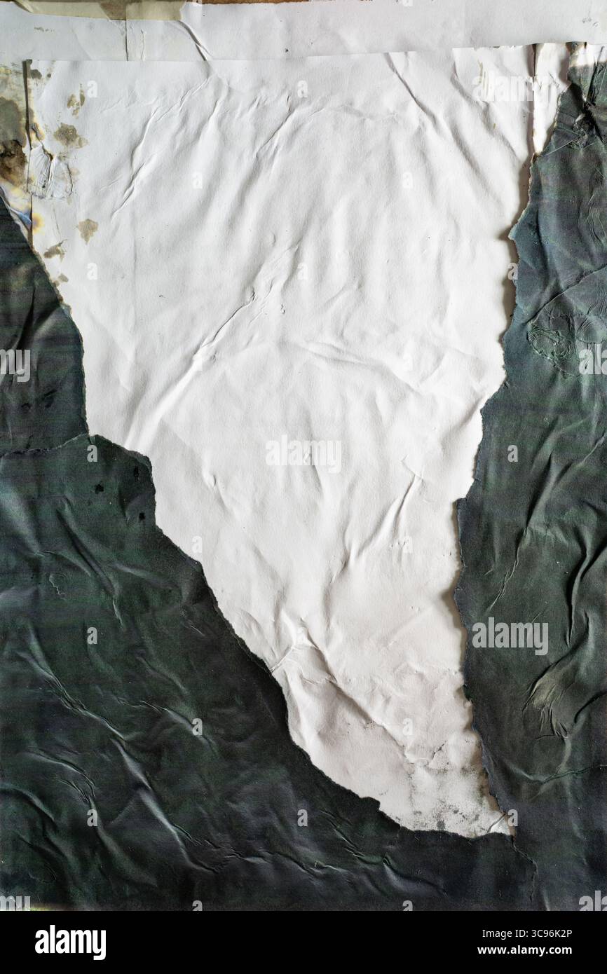 A black paper poster was peeled back to reveal a white, rough paper ...