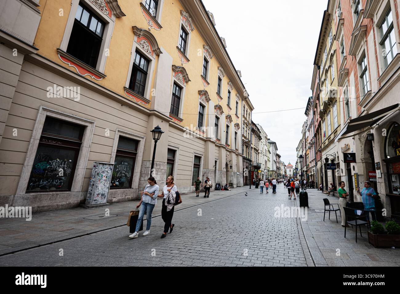Krakow, Poland - July 08, 2025: A busy street in Krakow, Poland, with ...