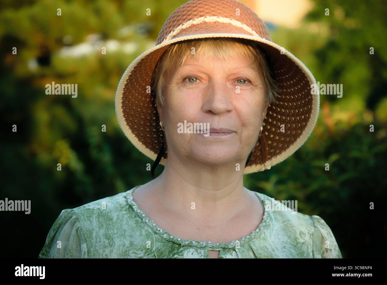 Portrait of a beautiful middle-aged woman in sun hat. Selective focus ...