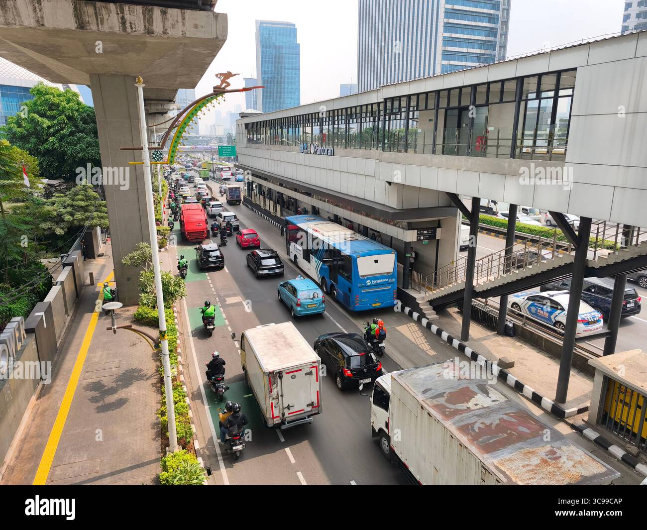 Transjakarta buses as a means of public transportation enter a bus stop to pick up and drop off ...