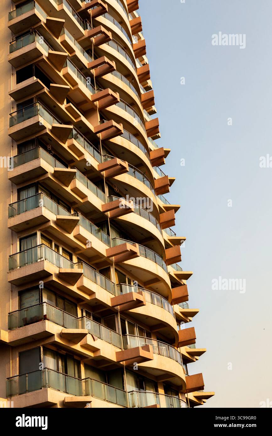 Modern high-rise residential building with distinctive balconies and ...