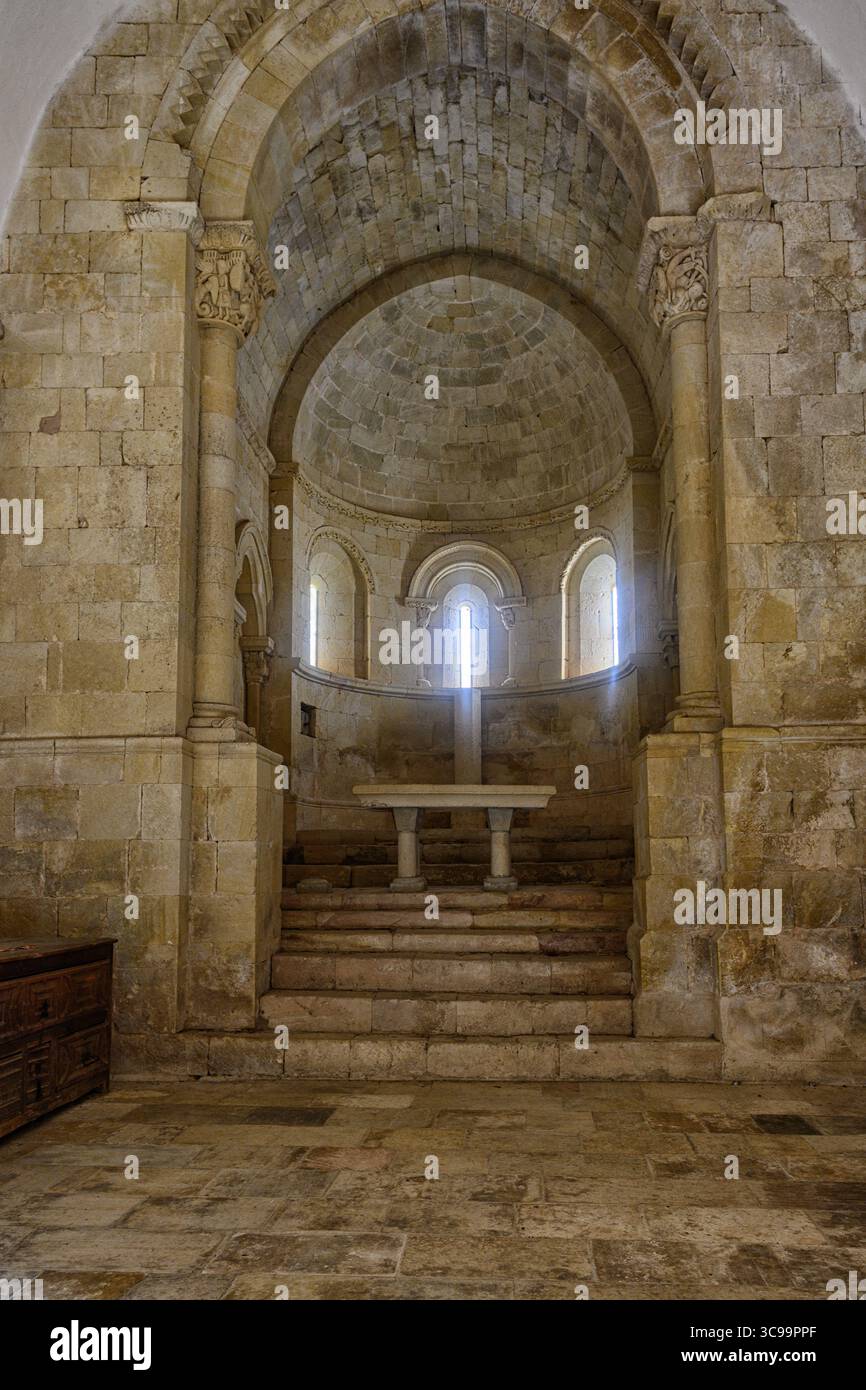 Medieval stone altar and vaulted apse inside Romanesque chapel with ...