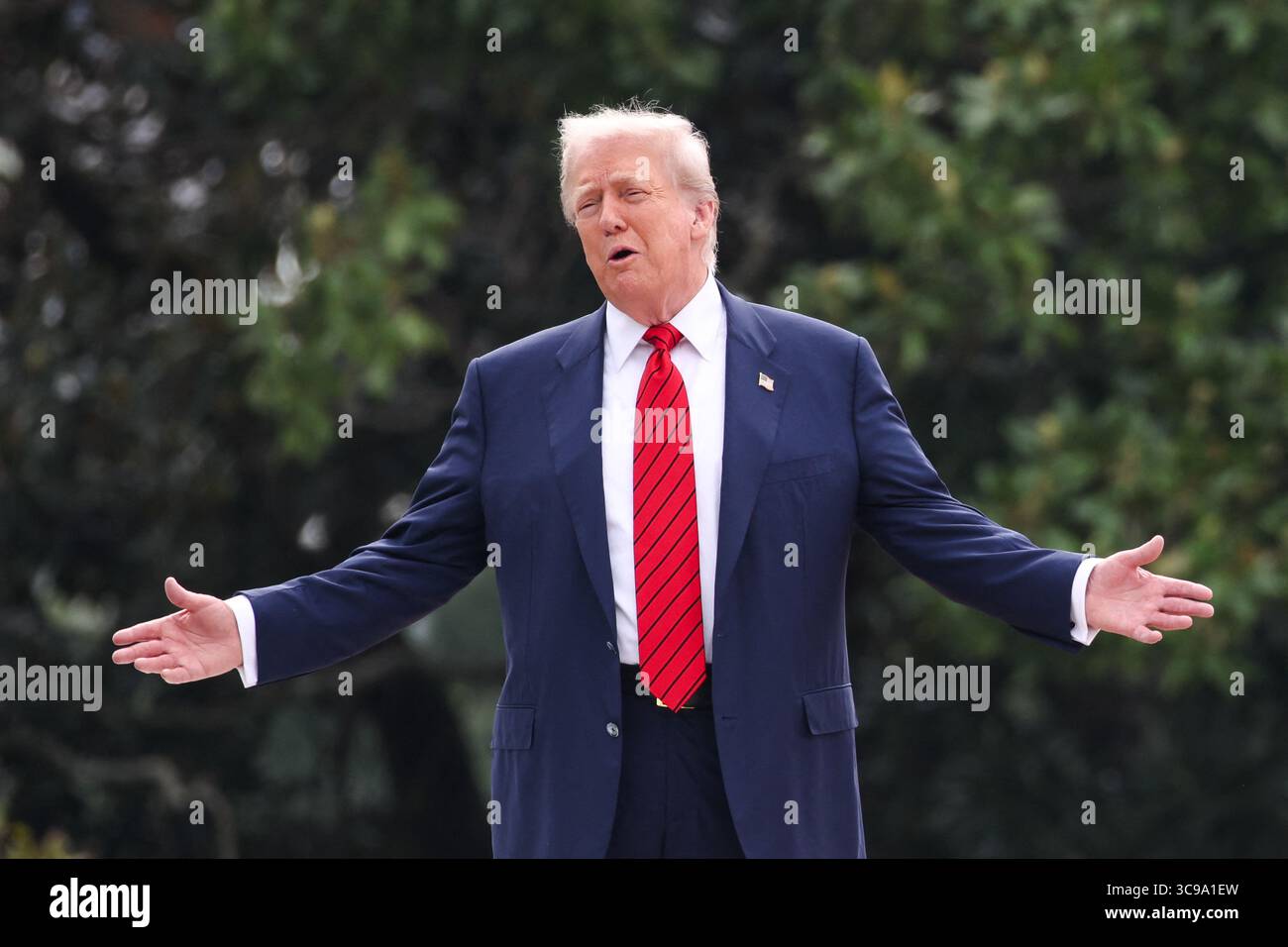 President Donald Trump gestures to the media from the roof of the West ...
