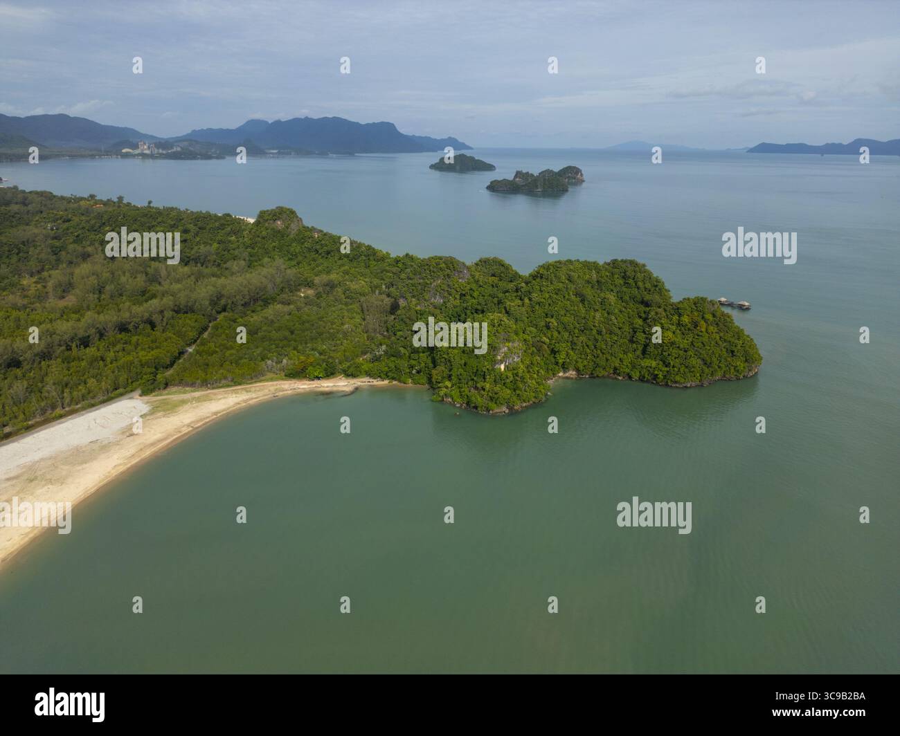 Aerial view of emerald waters embrace the verdant coastline near Rebak ...