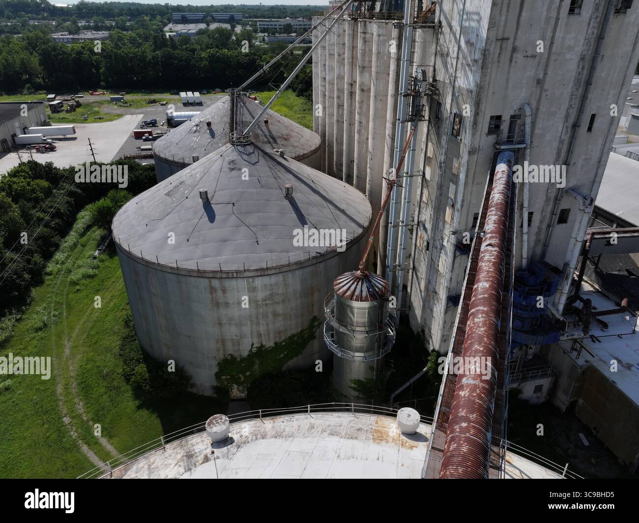 Aerial view of weathered concrete silos and aged industrial buildings ...