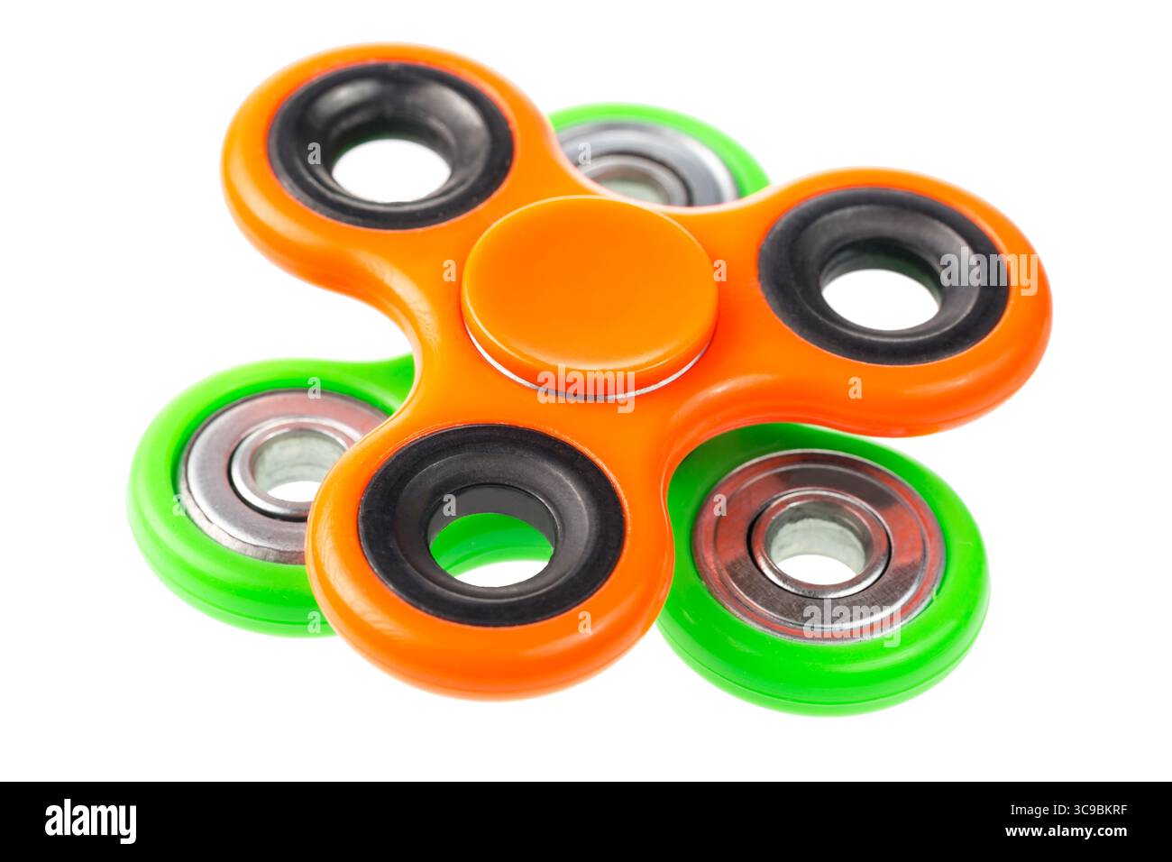 Orange and green fidget spinners close up on each other, stress ...