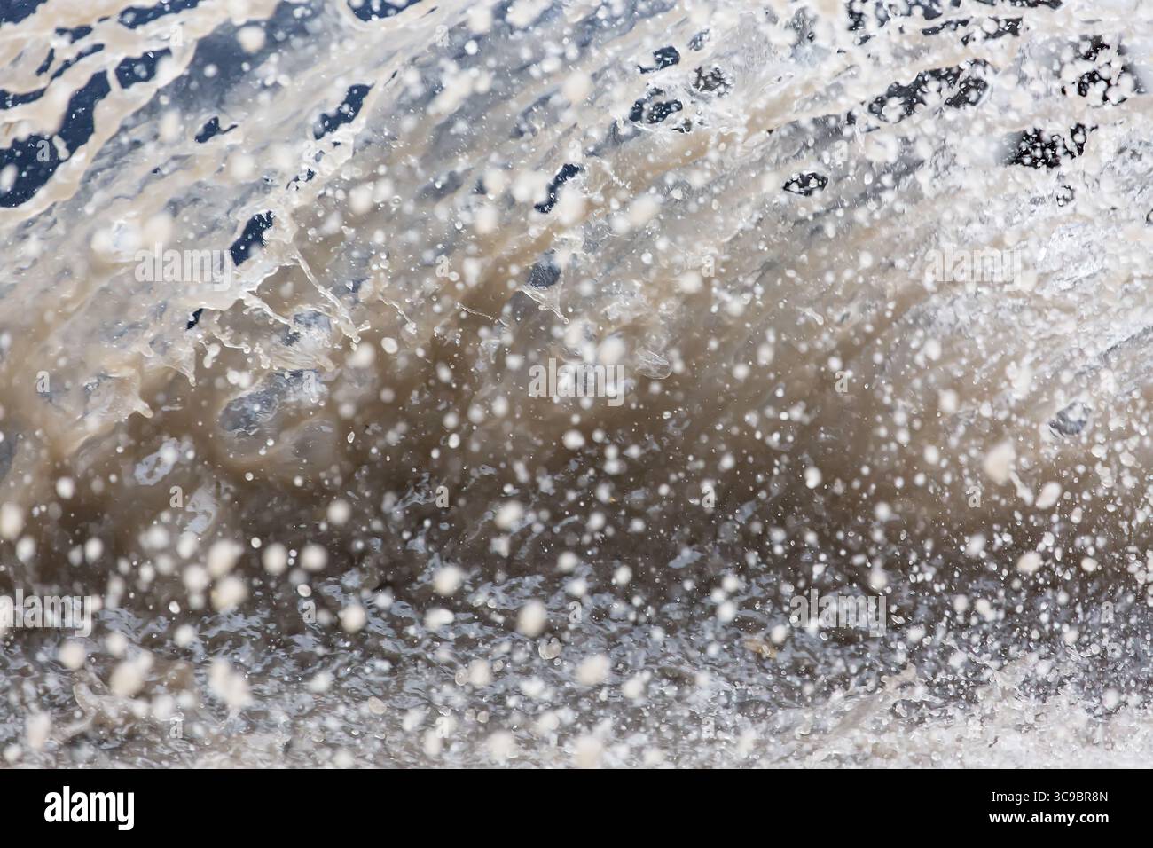 Dirty water splash from puddle on the street Stock Photo - Alamy