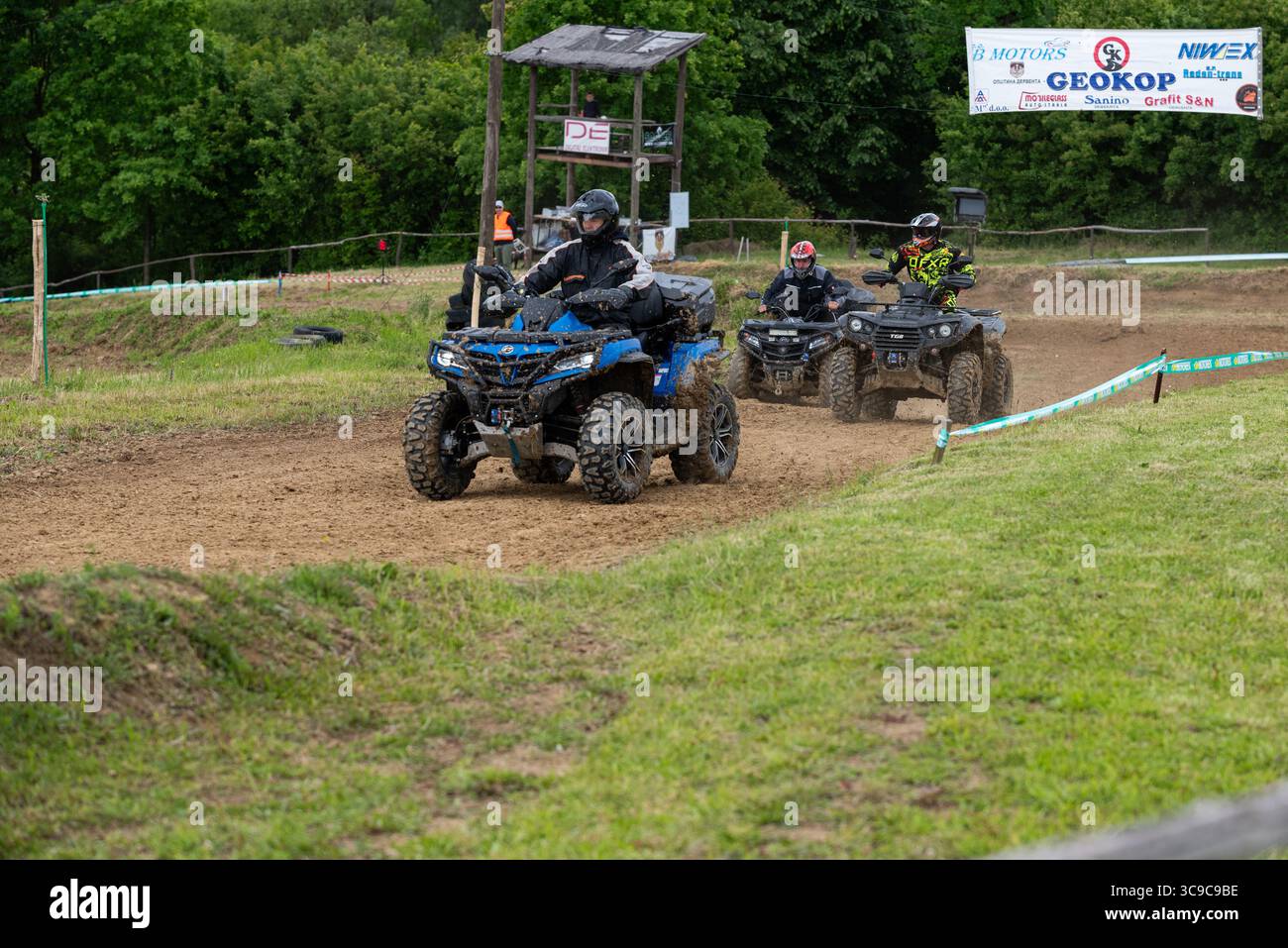Motocross rider on ATV vehicle on dirty motocross truck, riders show ...