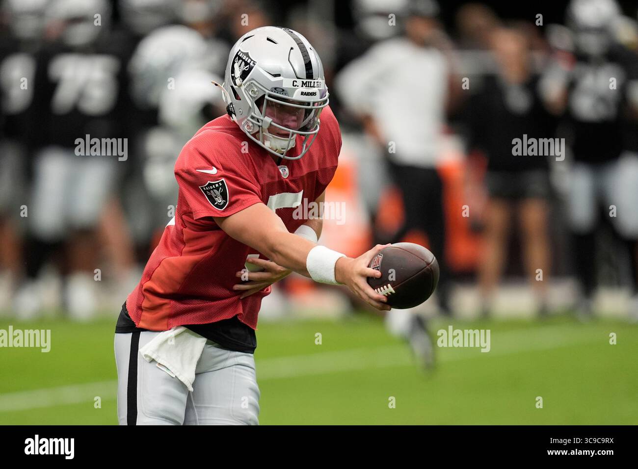 Las Vegas Raiders quarterback Cam Miller (5) takes part in practice at ...