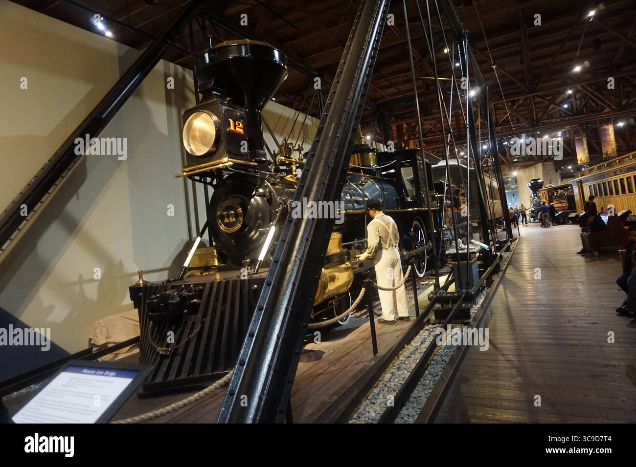 These show beautifully preserved steam locomotives displayed indoors ...