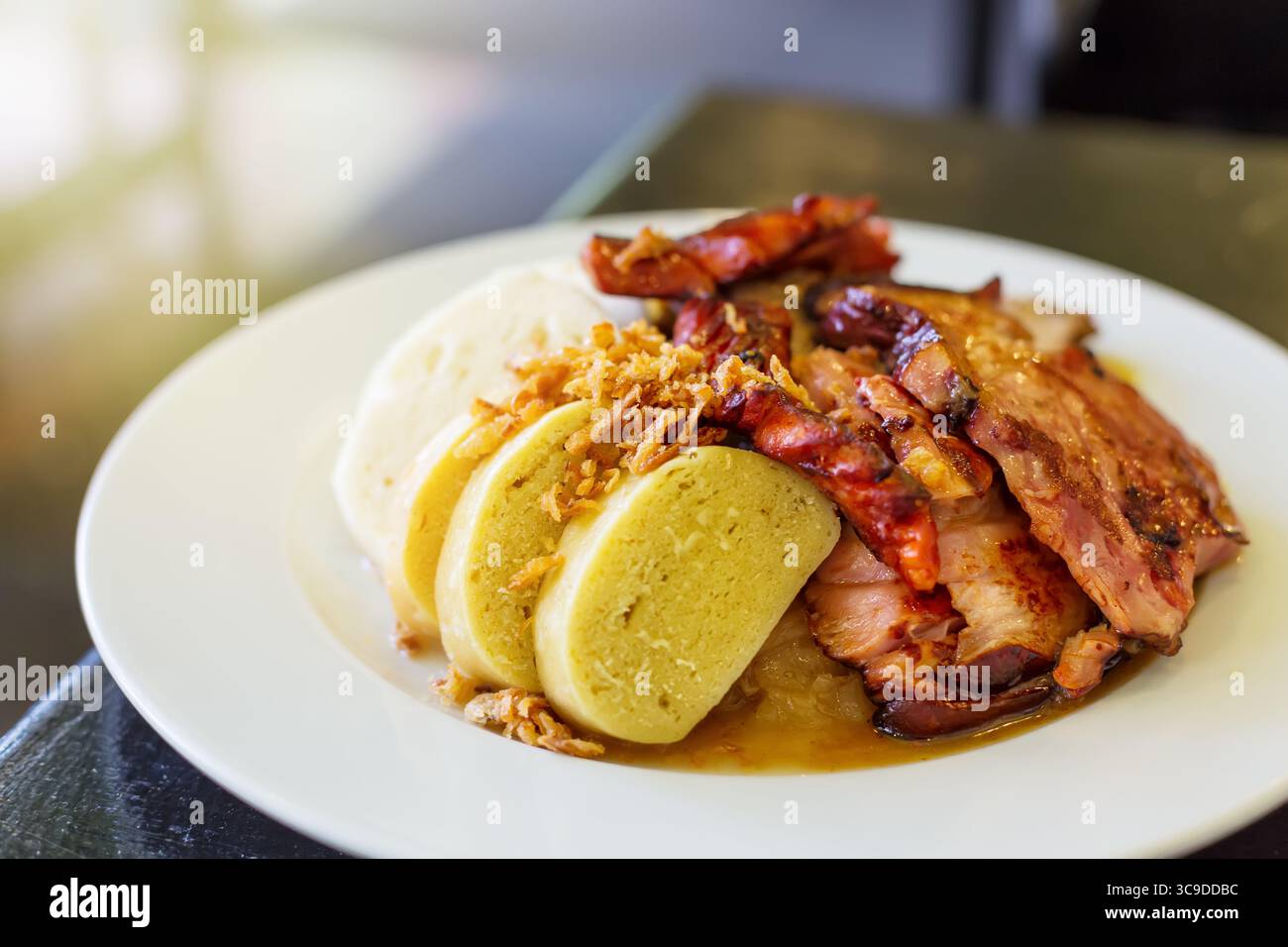 Czech traditional cuisine dumplings cabbage and pork meat on a plate ...