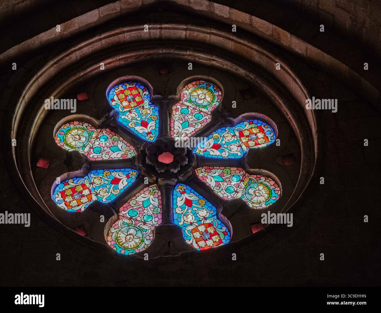 The beautiful stained glass rose window showcases vibrant Romanesque ...