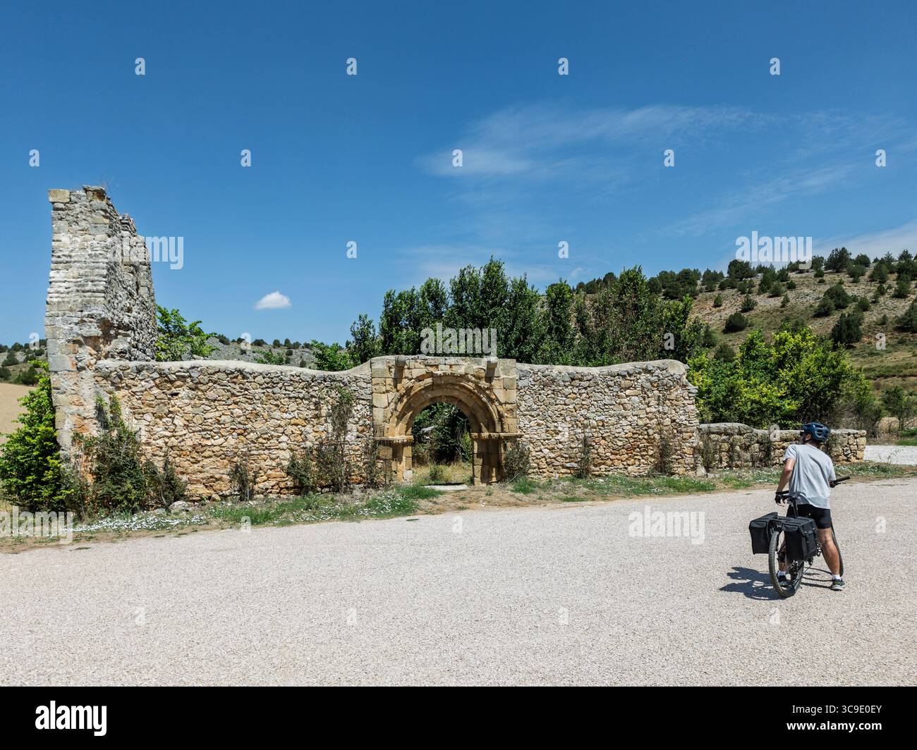 In Calatañazor, a cyclist takes a moment to admire the preserved ruins ...
