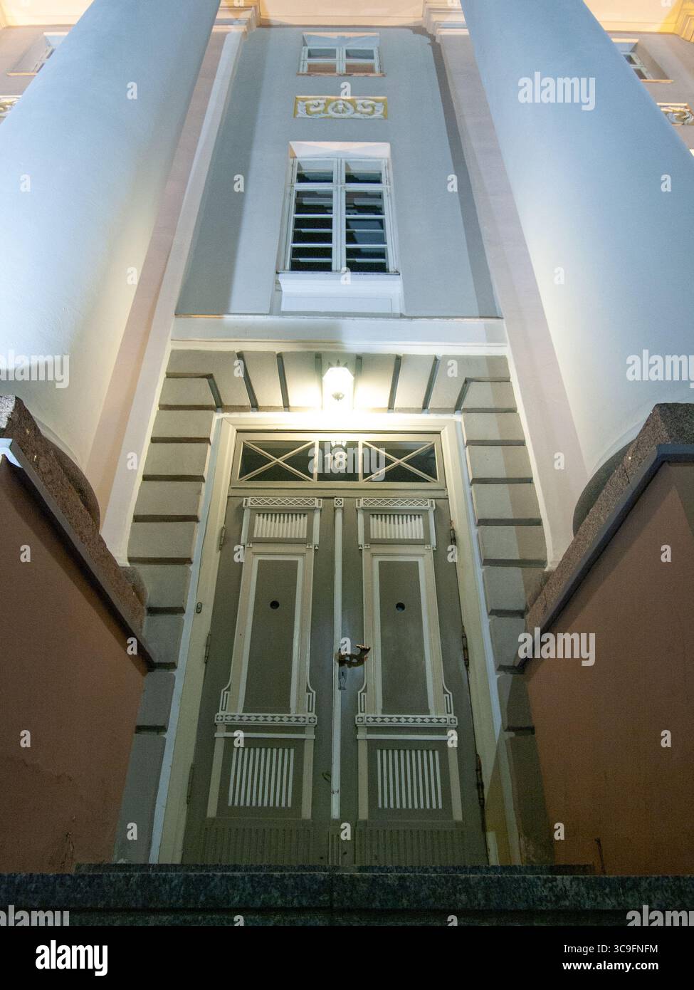 Tartu University main building entrance door at night, classic ...