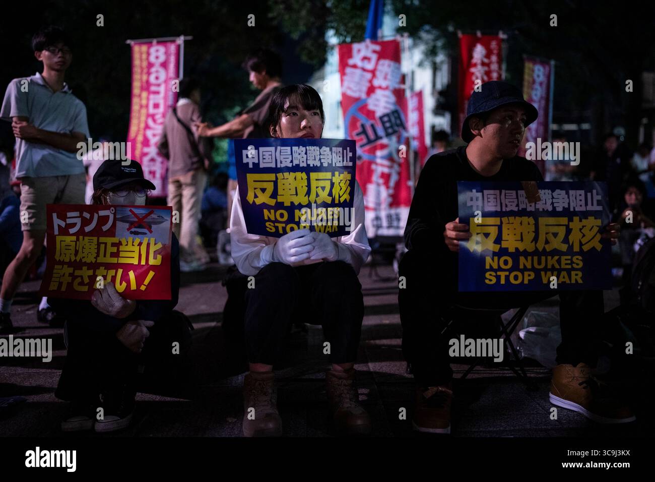 Protesters sit outside the Atomic Bomb Dome ahead of the memorial ...