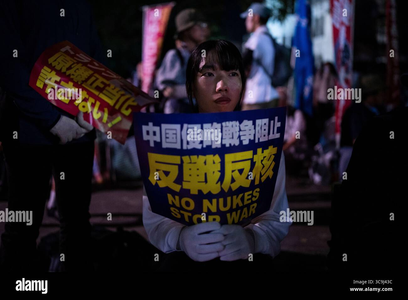 Protesters sit outside the Atomic Bomb Dome ahead of the memorial ...