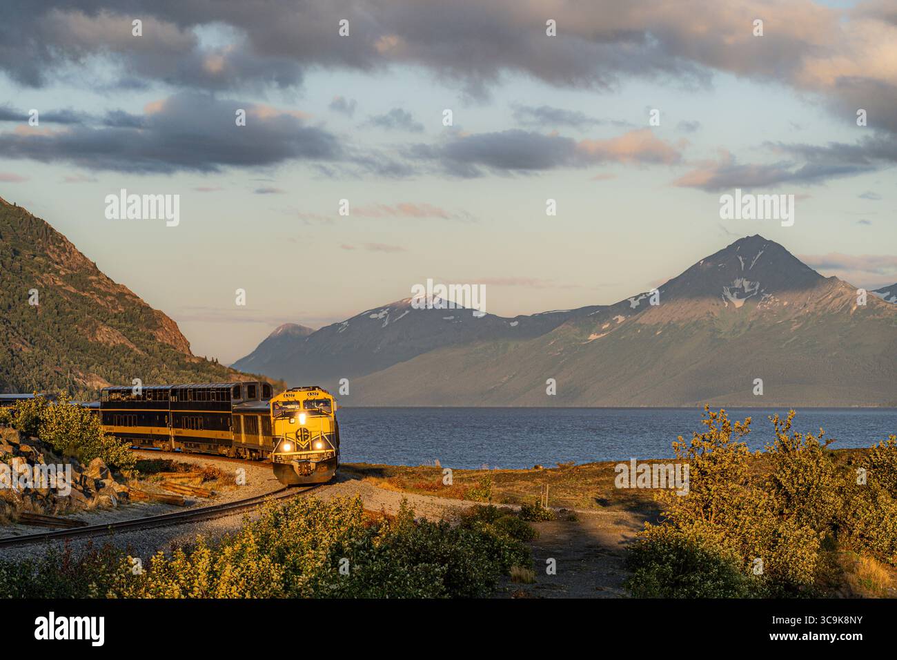 The Alaska Railroad train makes its way along Turnagain Arm. The ...