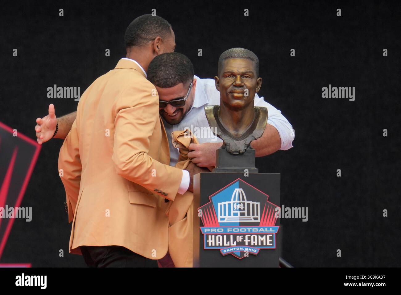 Former NFL player Eric Allen, left, gets a hug from his son Austin ...
